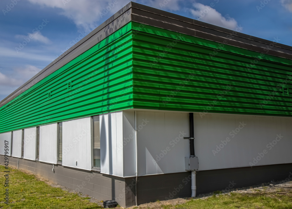 Daytime exterior corner view of single story commercial low rise flat ...