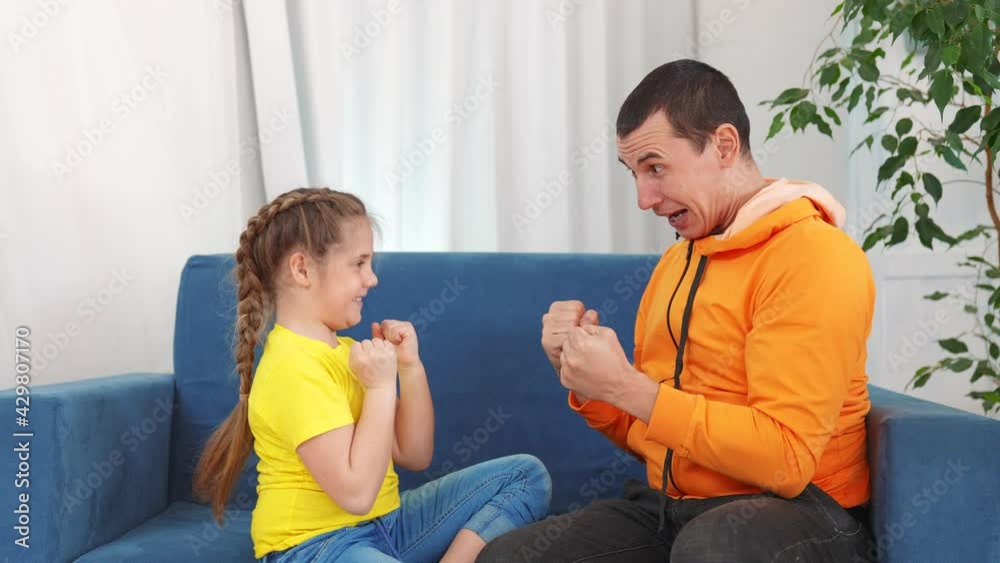 happy family teamwork. dad daughter clap their hands and hug rejoice ...