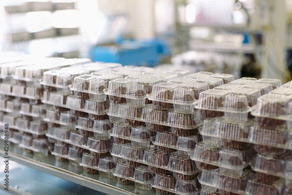 Packaged sweets in plastic containers. Confectionery factory. Stock ...