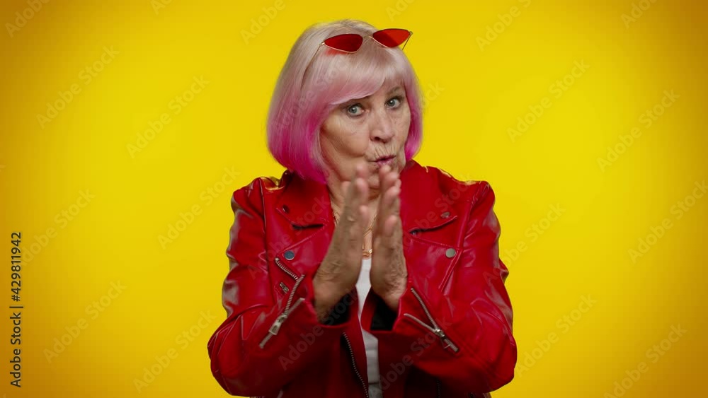 Mature old granny grandmother with pink hair in casual red jacket ...