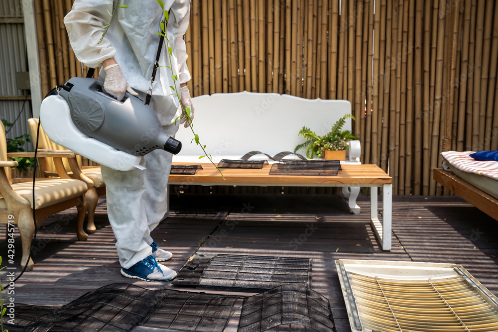 Professional technical man in prevention suit with his sterilizing ...