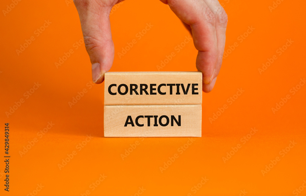 Corrective action symbol. Wooden blocks with words 'Corrective action ...