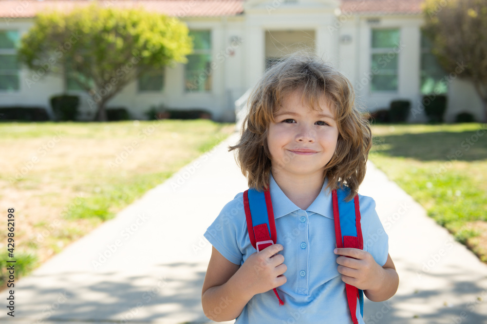 Portrait of happy school kid is going to school for the first time ...