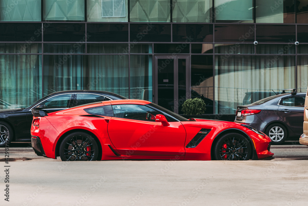 Fotka „Red Chevrolet Corvette C7 parked along the street. Side view of ...