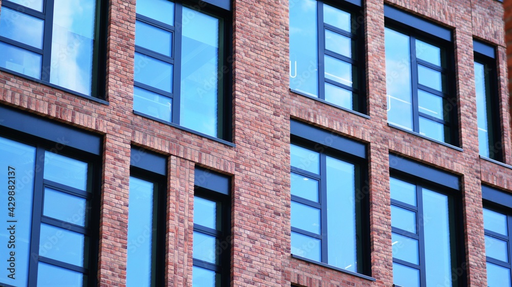 Modern brick and glass facade of the office building. A contrasting ...