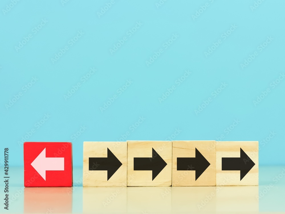 individual and standing out from the crowd concept. Red wooden cubes ...