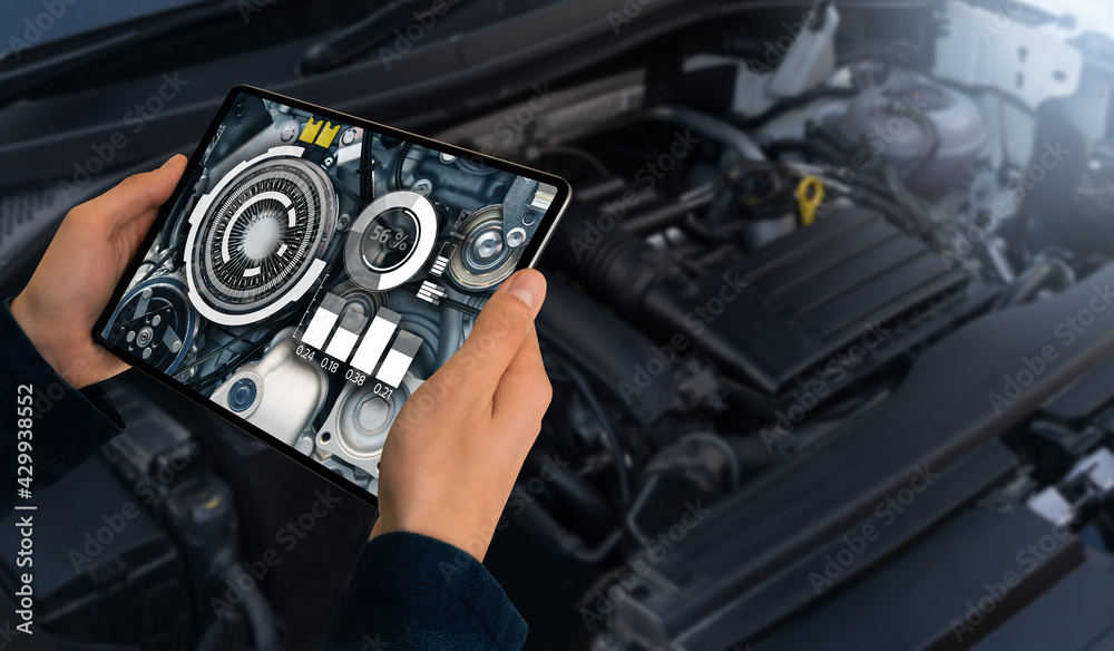Serviceman repairing a car using augmented reality application. Stock ... Serviceman repairing a car using augmented reality application. Stock ...