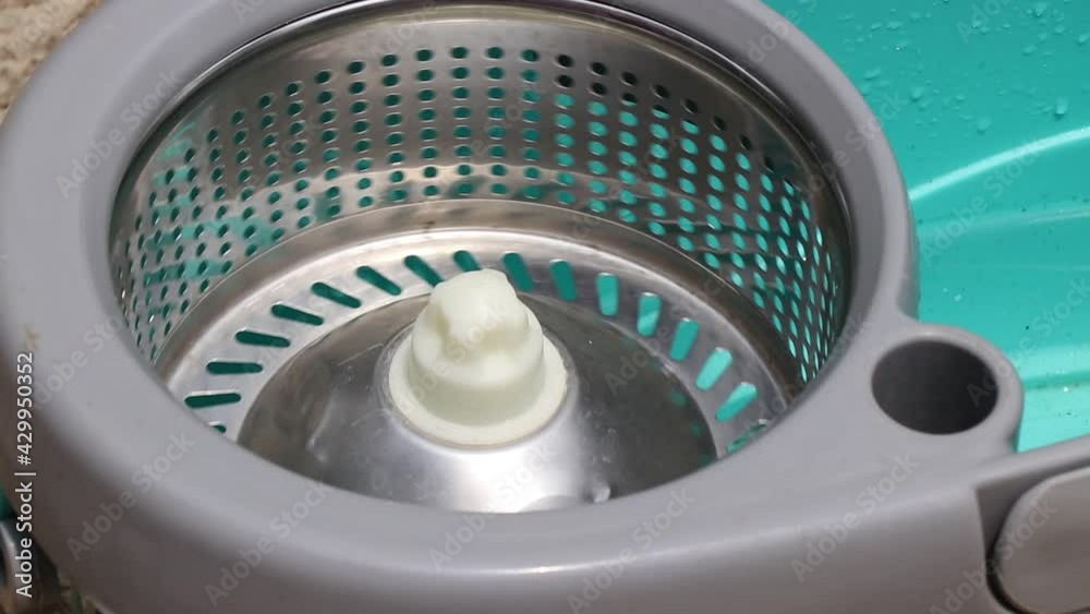 Centrifugal water extractor used to remove excess water from spin mop ...