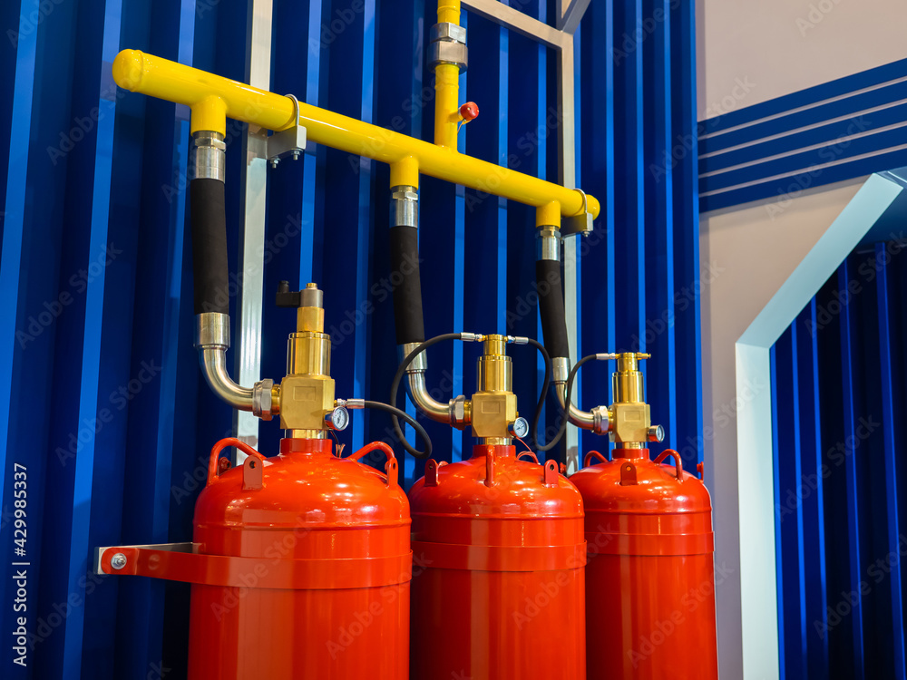 Fire extinguishing system cylinders on blue background. Industrial fire ...