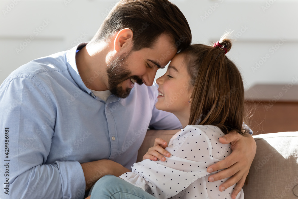 Caring young Caucasian father and little teenage daughter hug cuddle ...