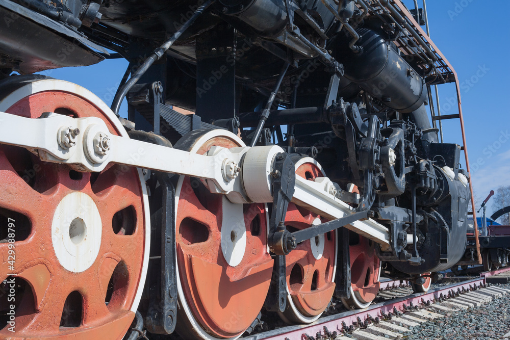 Iron wheels of mighty steam locomotives, red iron wheels of steam ...