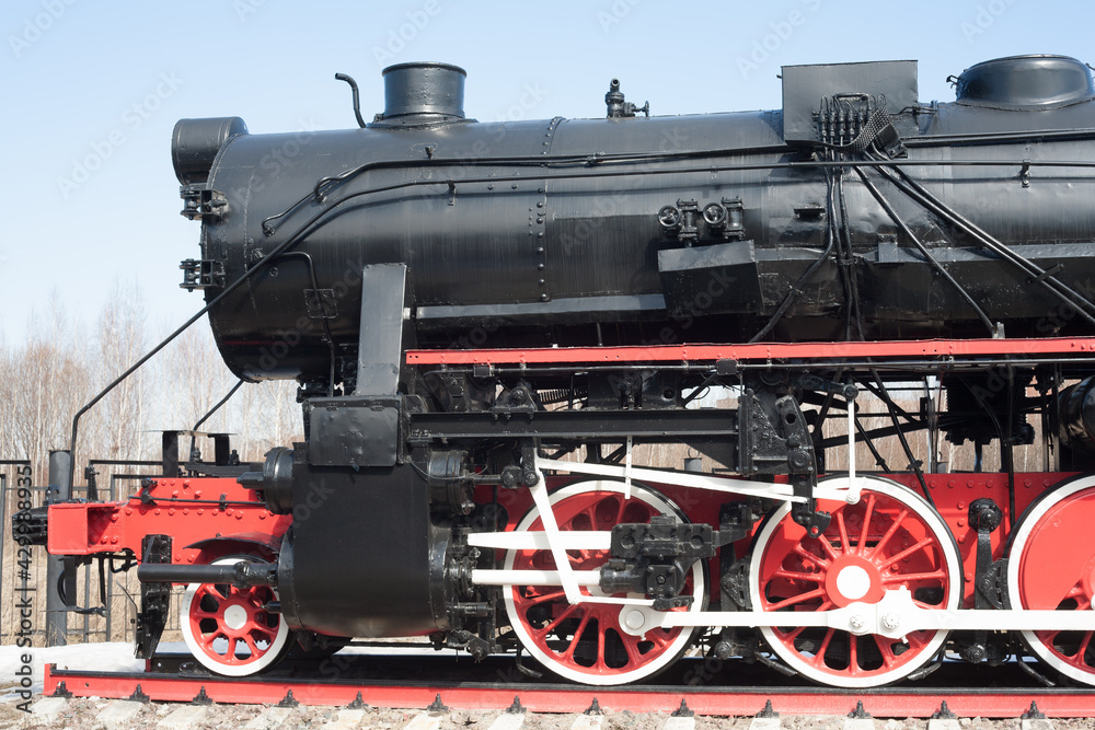 Iron wheels of mighty steam locomotives, red iron wheels of steam ...