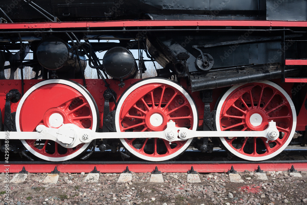 Iron wheels of mighty steam locomotives, red iron wheels of steam ...