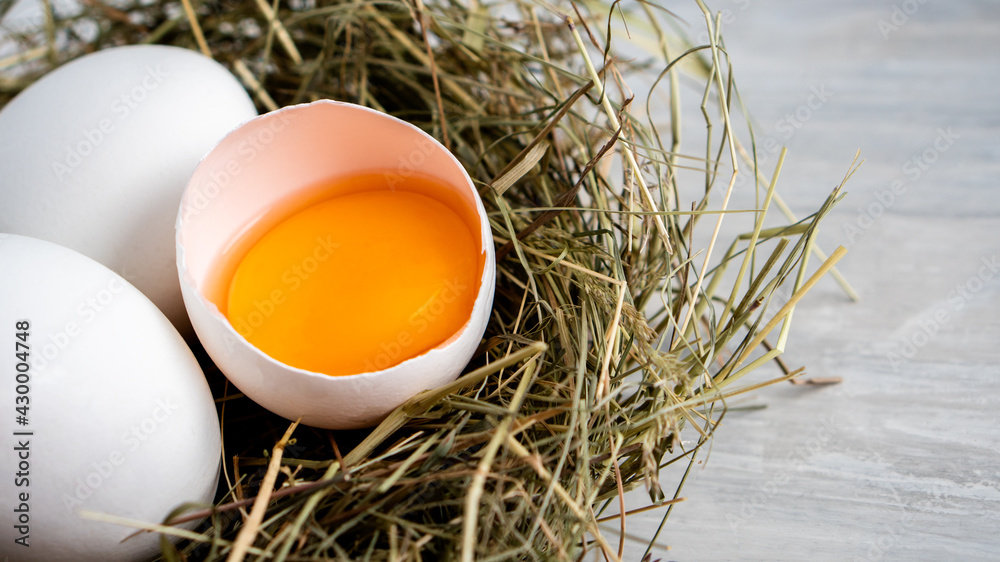 Closeup raw white brown organic fresh eggs shell with yolk from happy ...