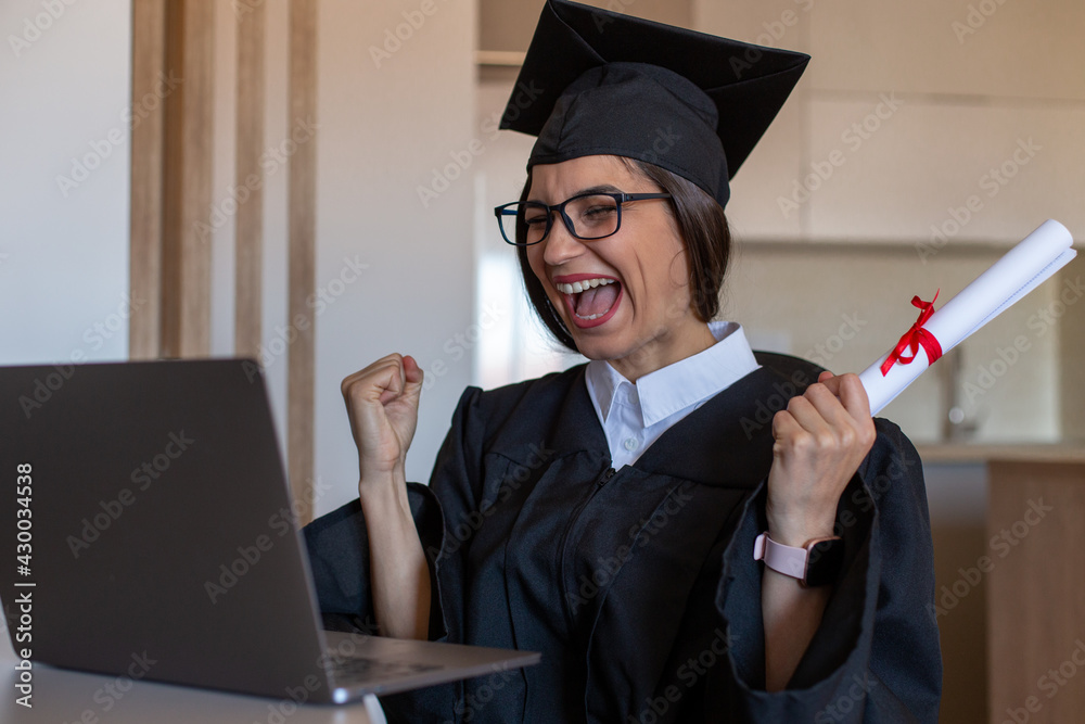 Happy smiling female student is graduating online at home with an ...