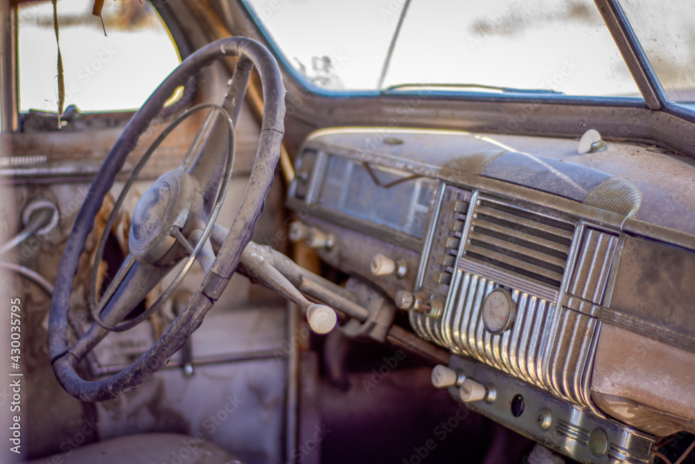 Interior view of the dash board of an old junked retro vehicle in a ...