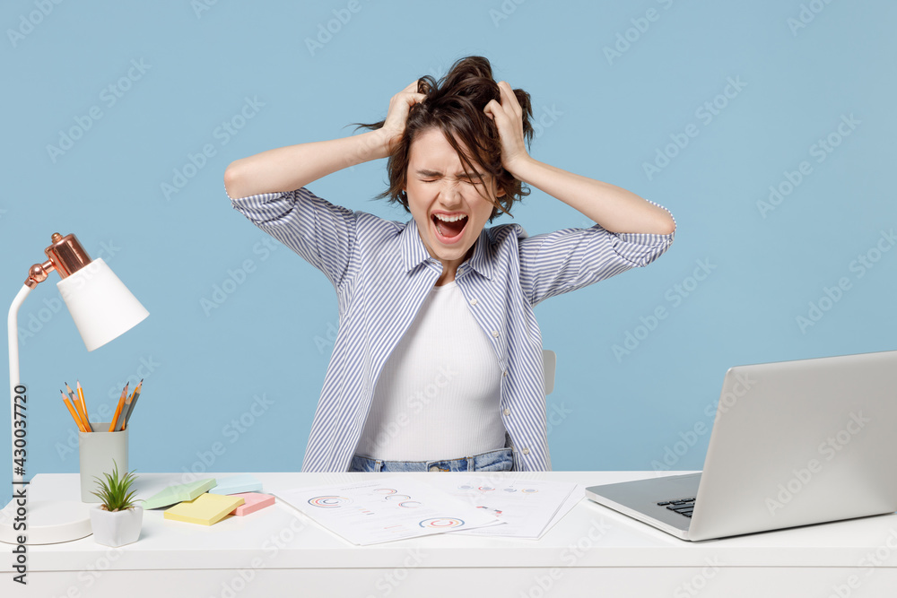 Young troubled stressed employee business woman 20s in casual shirt sit ...