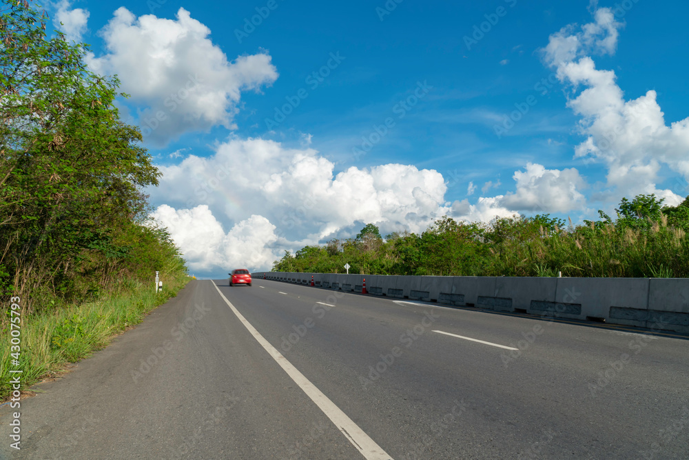 Beautiful road with blue sky in sunny day have a red car on the road in ...