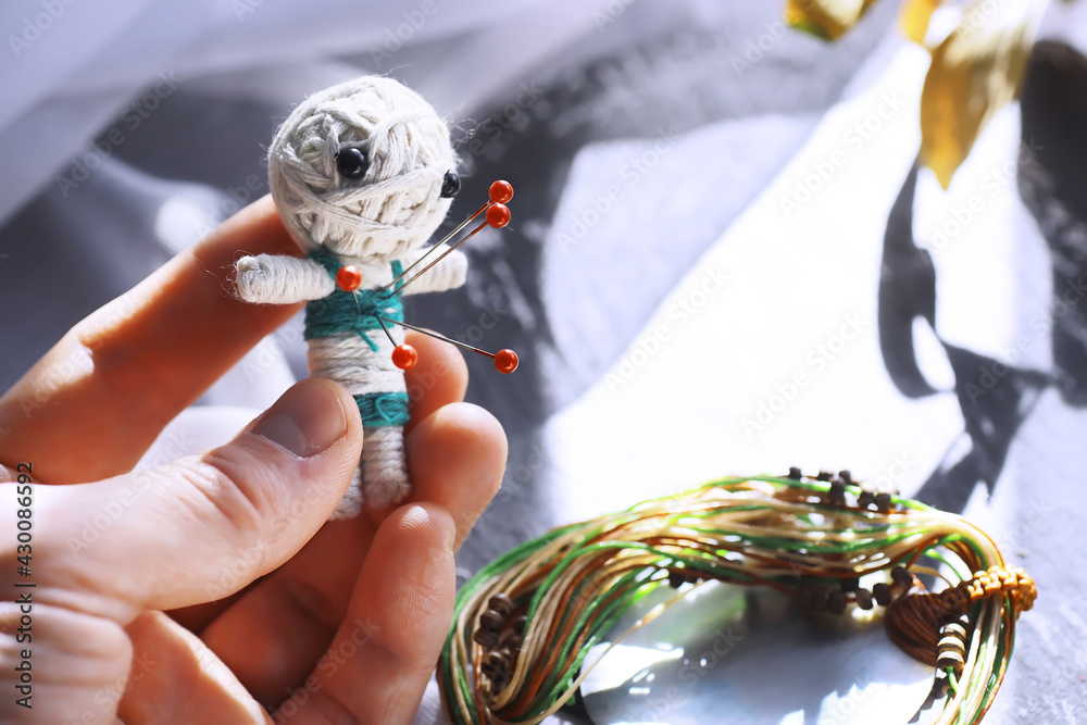 Voodoo Doll on a stone background with dramatic lighting. Mystic still ...