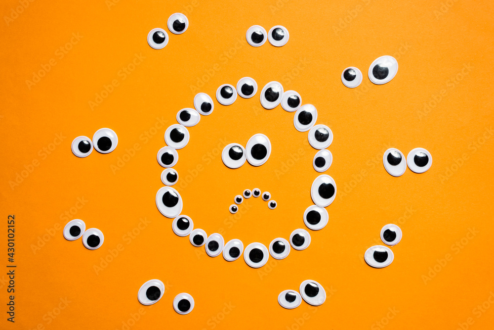 Sad smiley face from toy eyes in the surroundings of other eyes on an ...