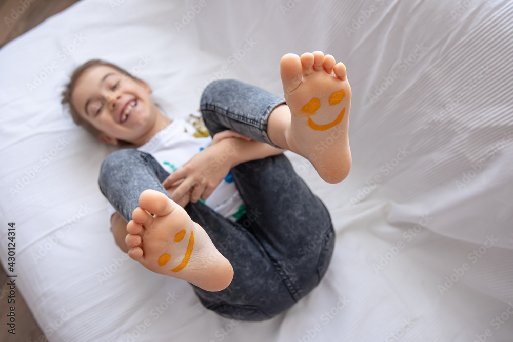 Close up of little girl's feet painted with smiles. Stock Photo | Adobe ...