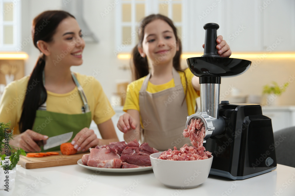 Happy family making dinner together in kitchen, daughter using modern ...