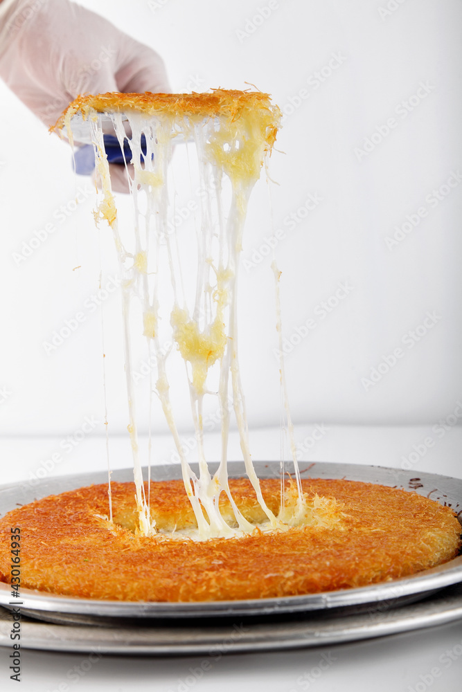 Turkish dessert kunefe, kunafa, kadayif with pistachio powder and ...