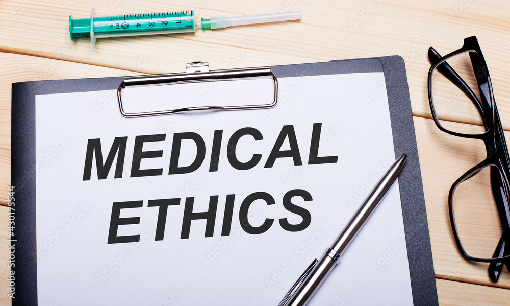 The words MEDICAL ETHICS is written on a white piece of paper next to ...