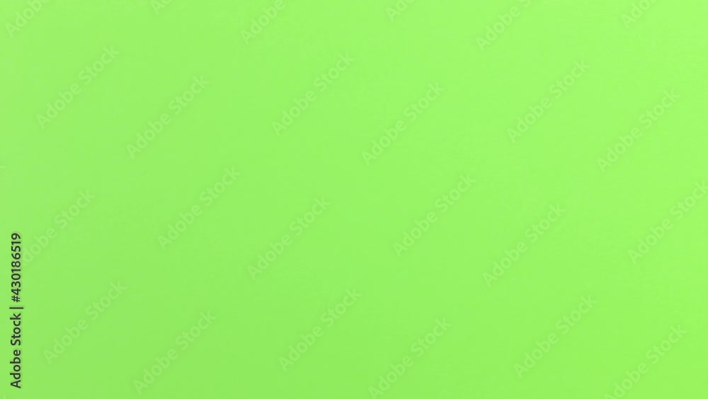 Stop Motion Animation_Green paper ball unwrapping on orange background ...