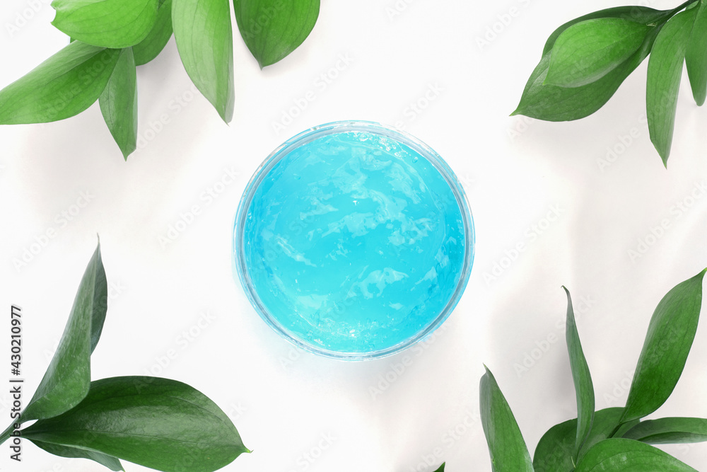 Liquid transparent gel for cleansing the face in a transparent jar on a ...