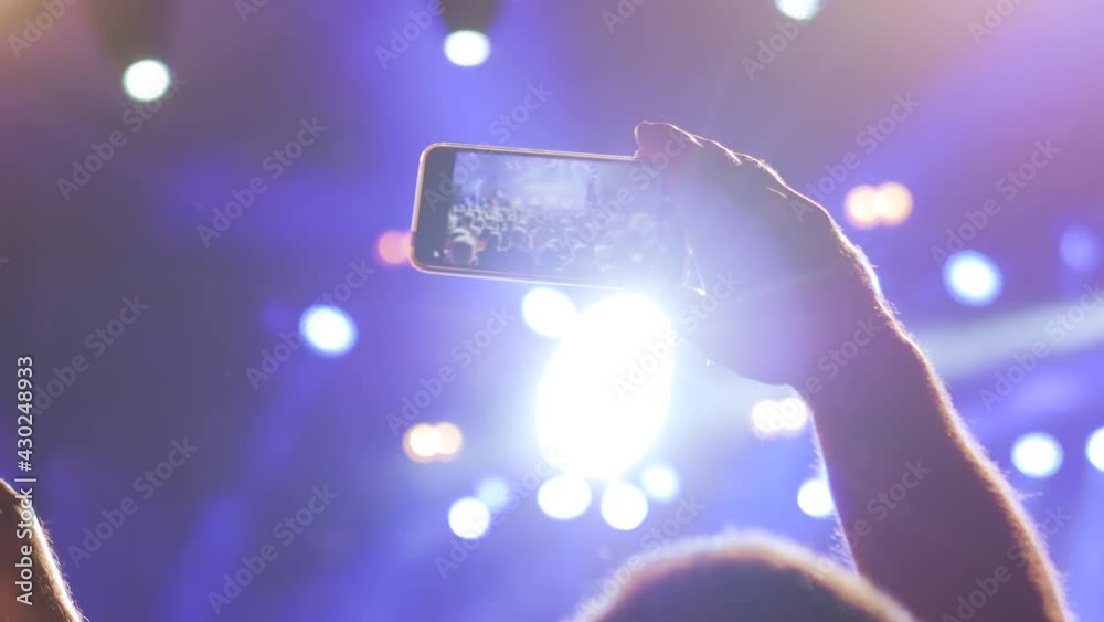 Close up: man hands taking photo or recording video of live music ...