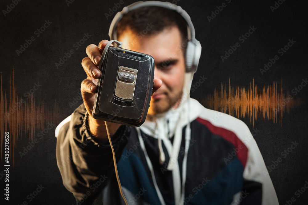 Radio day. Man listening music in headphones. Oldschool cassette player ...