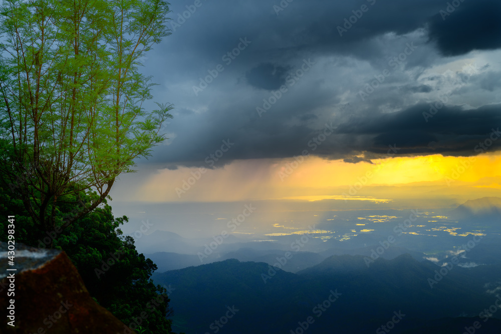 Rain and the dark clouds in the distance view from a mountain top ...