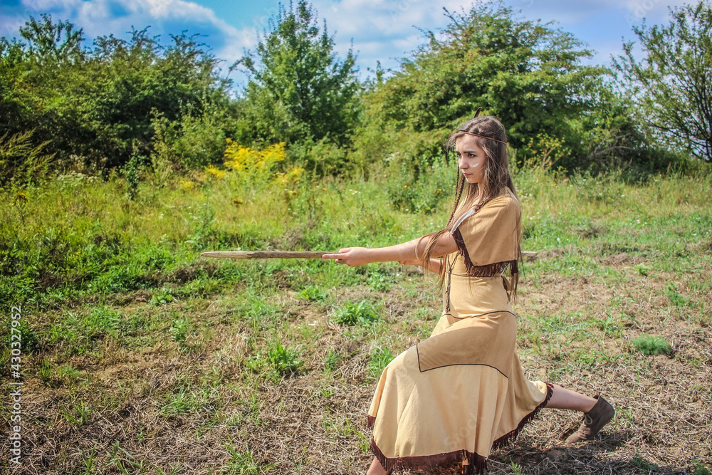 Apache tribe warrior striking with a spear, beautiful young girl in ...