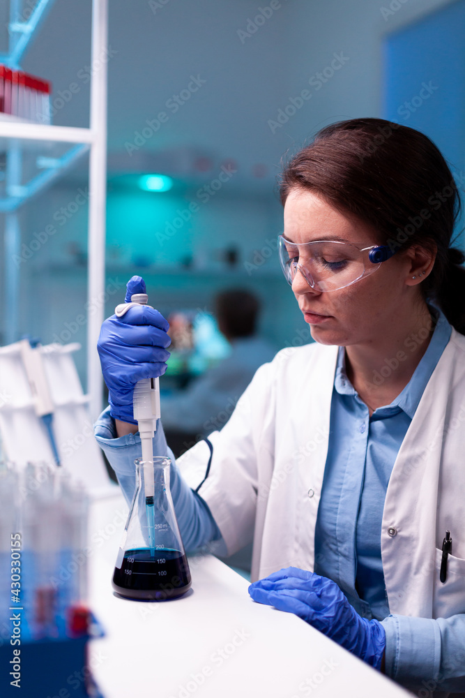Healthcare scientist using laboratory dropper micropipette during ...