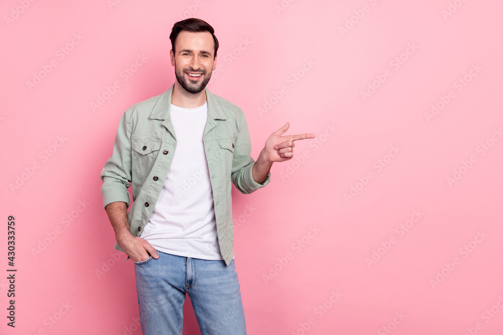 Portrait of attractive cheerful guy demonstrating copy empty space ad ...