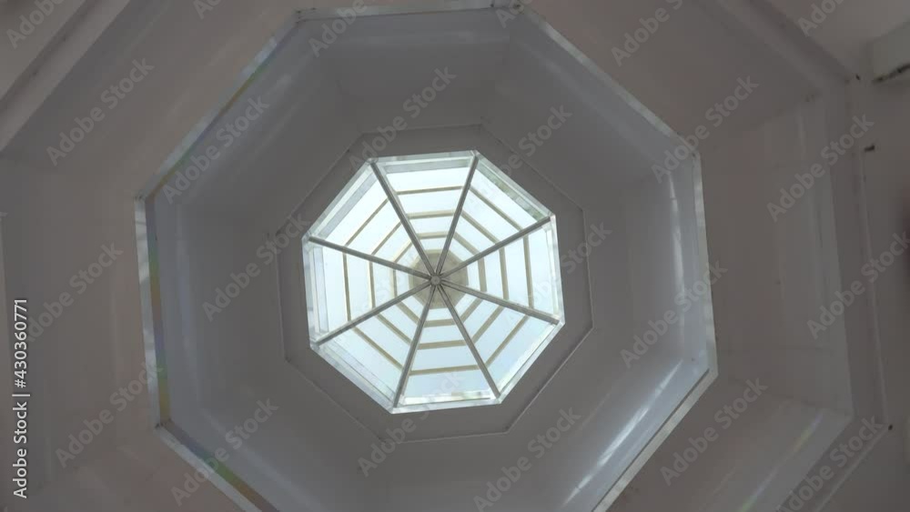 Concrete octagonal roof with glass in the center. Hypnotic rotation ...