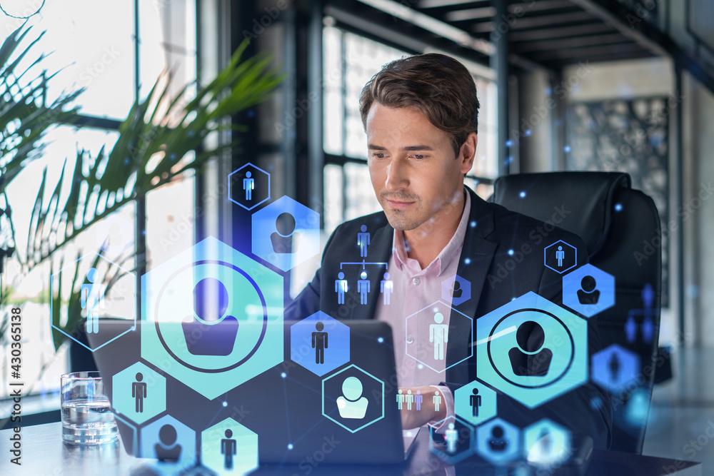 Handsome businessman in suit at workplace working with laptop to hire ...
