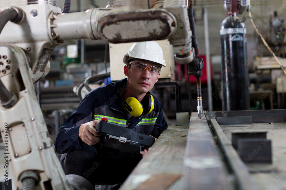 Male engineer worker maintenance automatic robotic machine in the ...