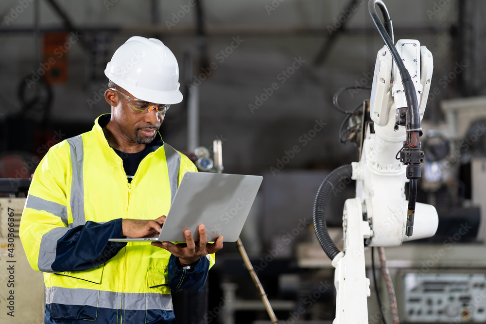Foto de African American male engineer worker using computer notebook ...