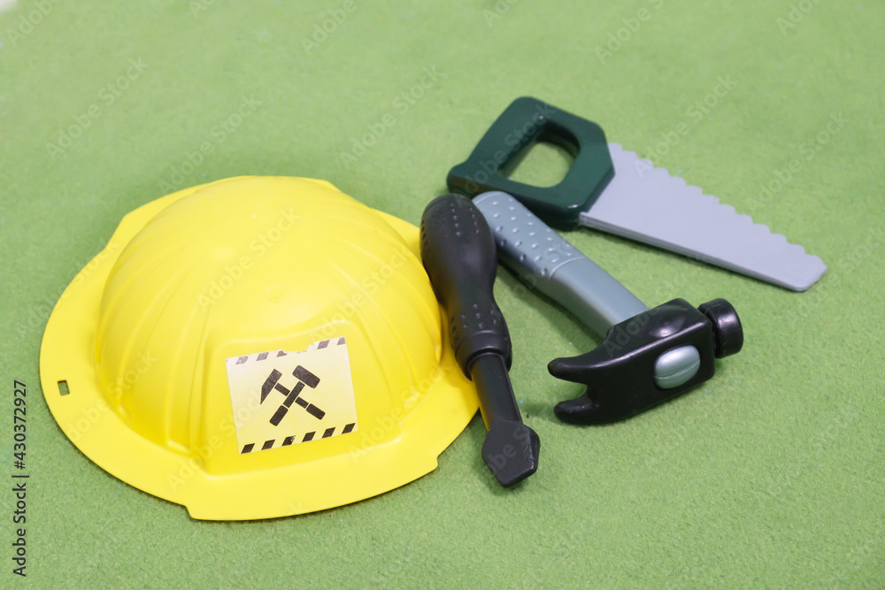 Kids builder toy set. Plastic yellow construction hard hat and tool kit ...