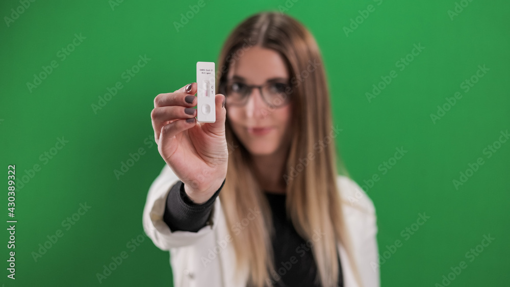 Corona self-test is negative - young woman shows the result - studio ...