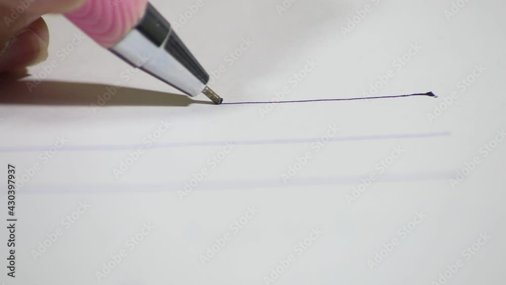 Close-up pen drawing a blue line on a white piece of paper. Abstract ...
