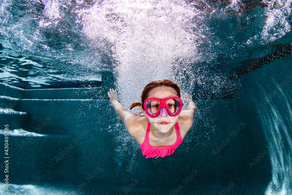 Girl diving in swimming pool Stock Photo | Adobe Stock