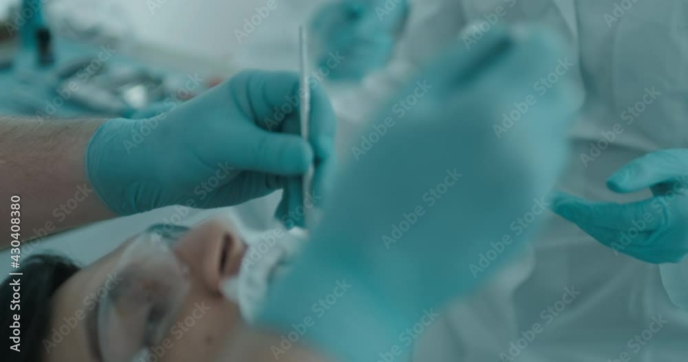 A female medical worker is taking a bite frame Y-shape clamp with ...