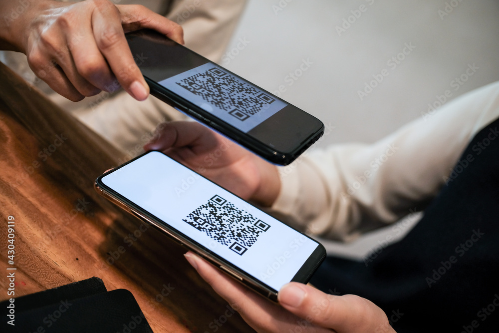 Qr code payment. Woman scanning QR code online shopping cashless ...