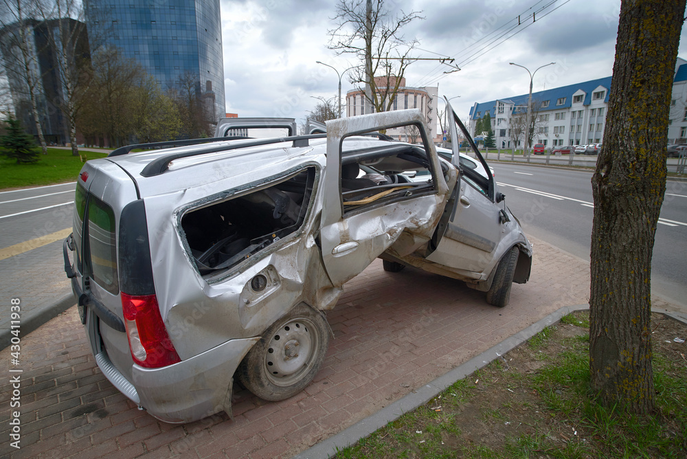Destroyed car after side impact collision with light pole. Wrinkled ...