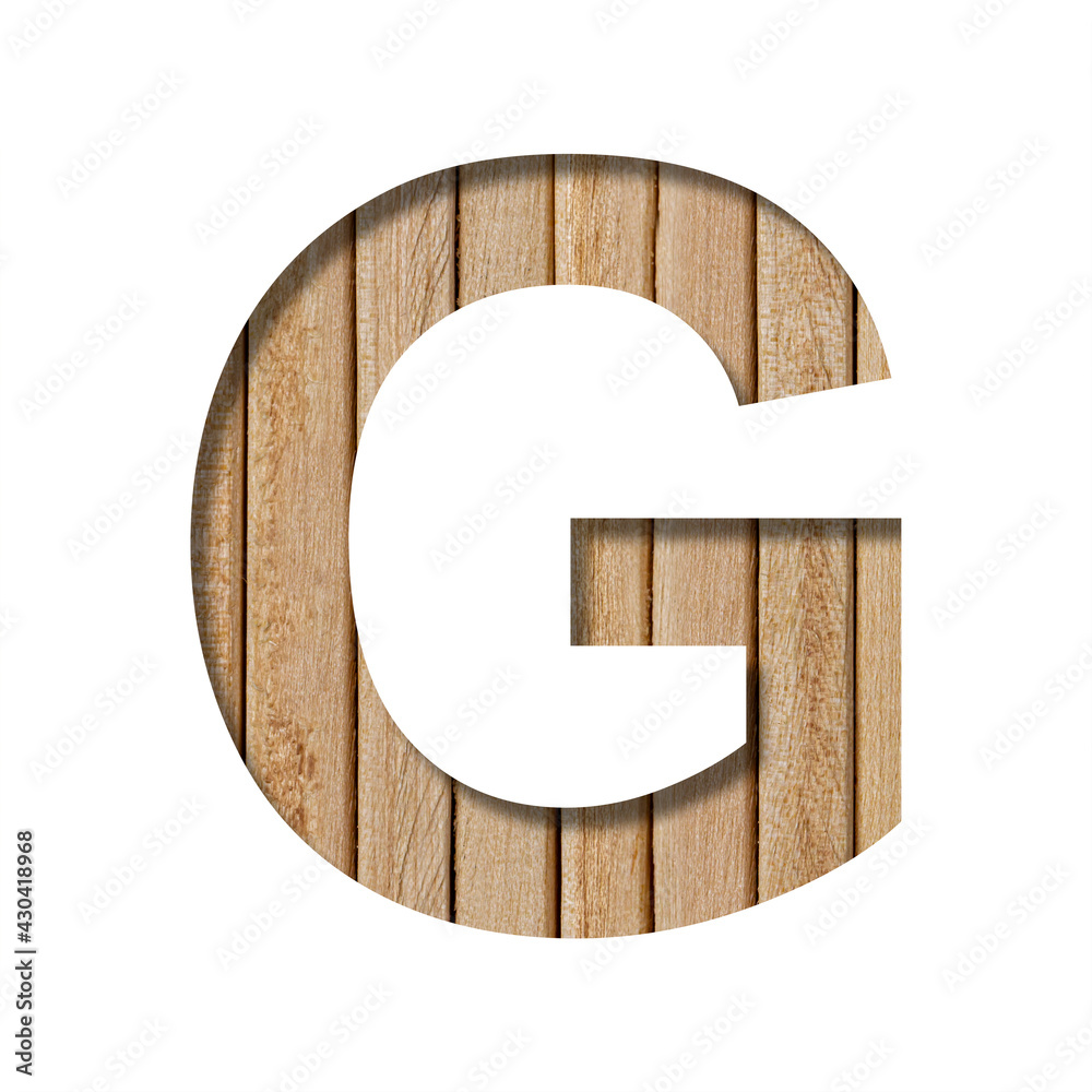 Font on light wood. Letter G is cut out of paper on a the background of ...