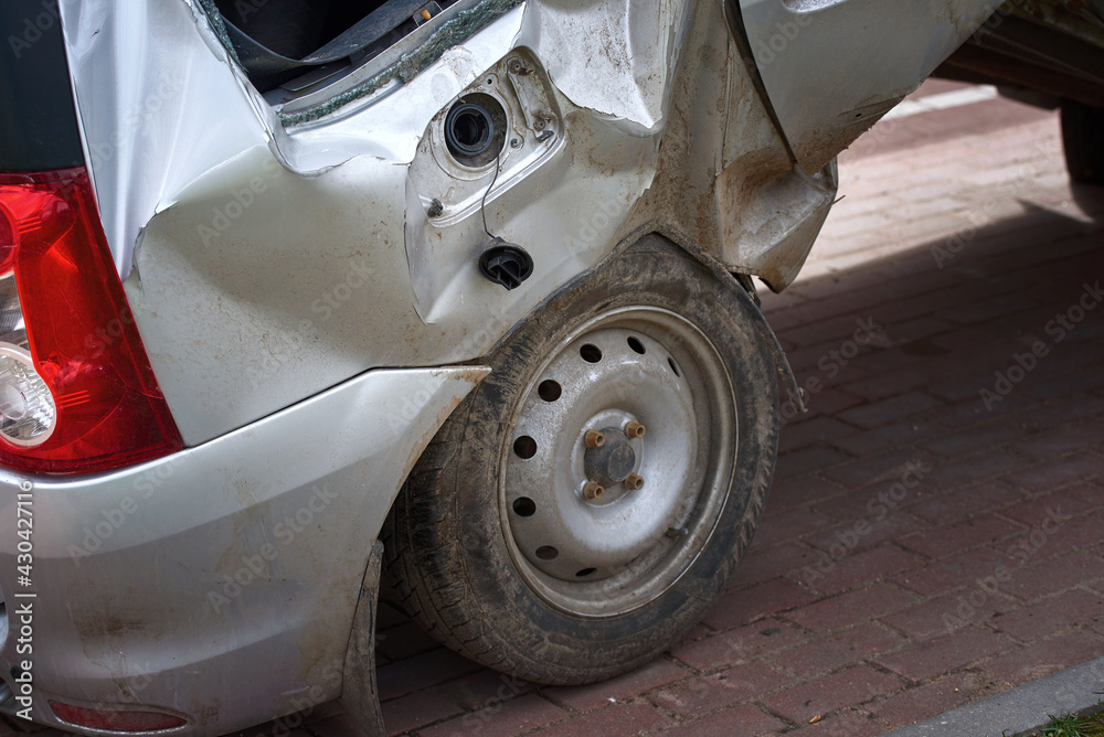 Damaged fuel tank cap, destroyed car after side impact. Wrinkled metal ...