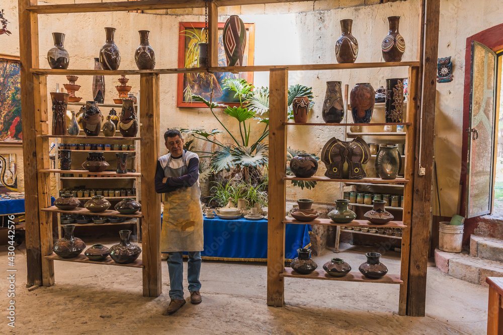 Mexican potter craftsman, showing his clay work made with his hands in ...
